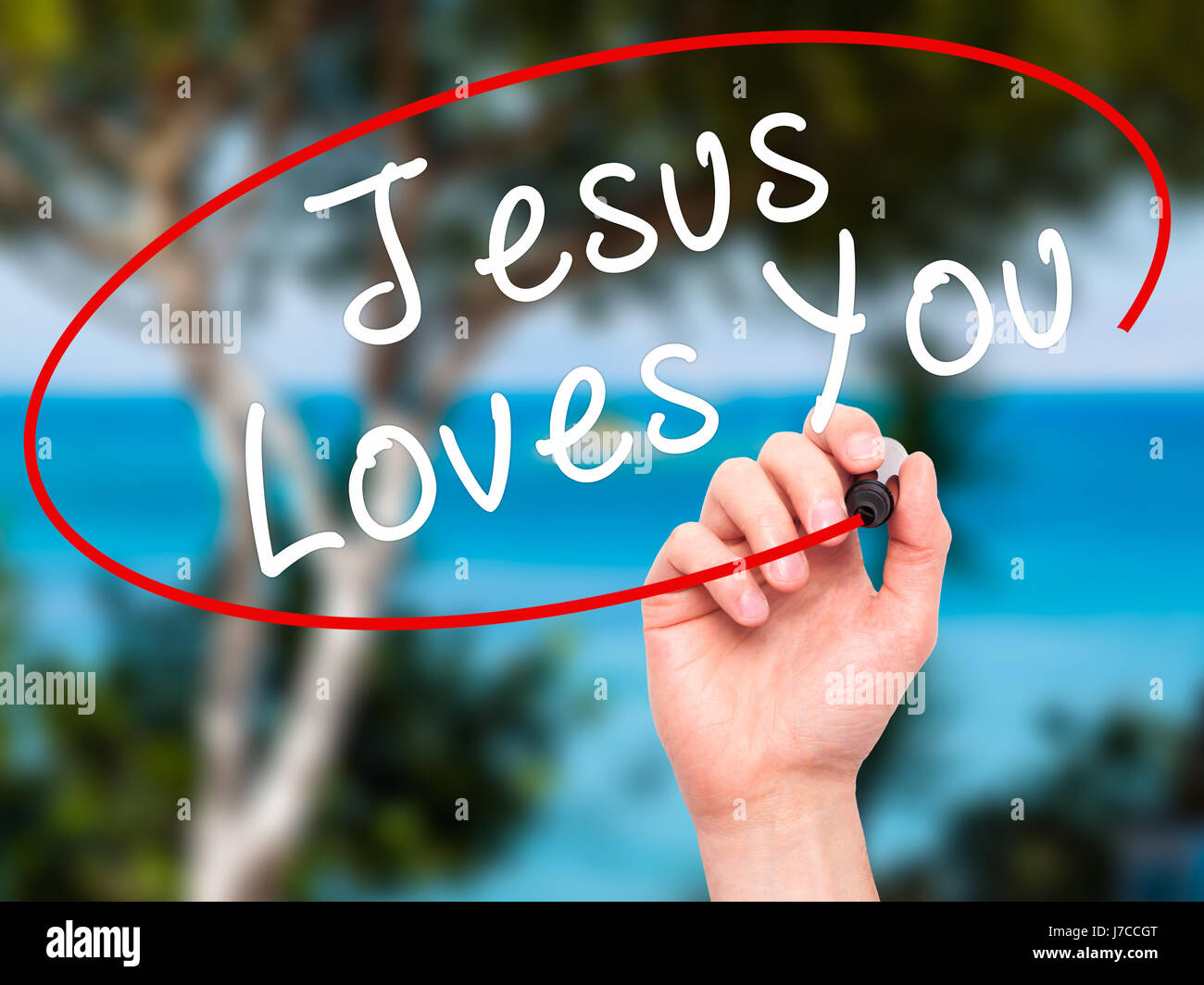 Man Hand writing Jesus Loves You with black marker on visual screen ...