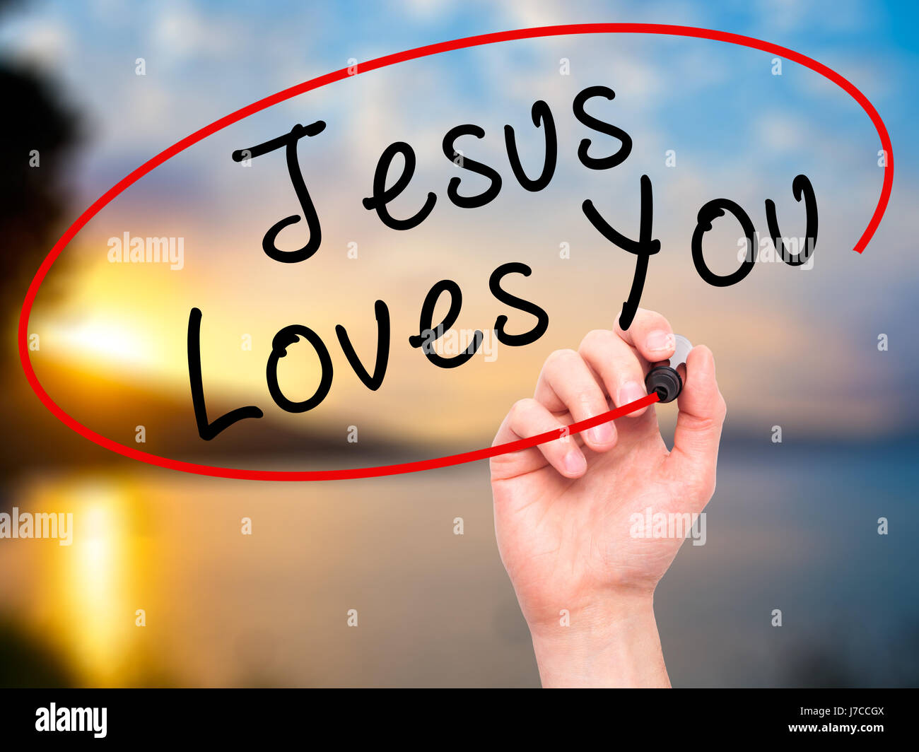 Man Hand writing Jesus Loves You with black marker on visual screen ...