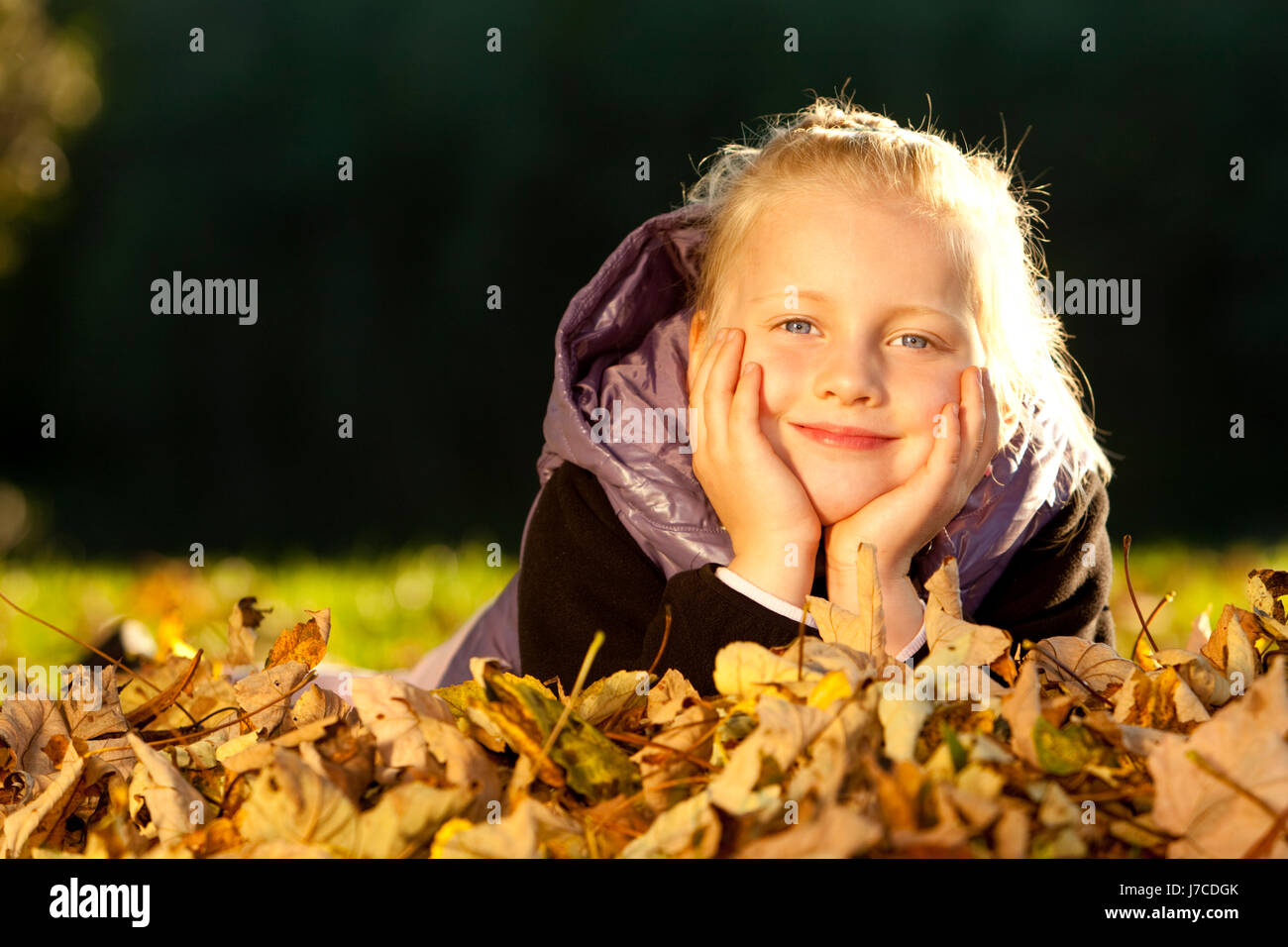 leaves lie lying lies child girl girls foliage nature fall autumn laugh ...