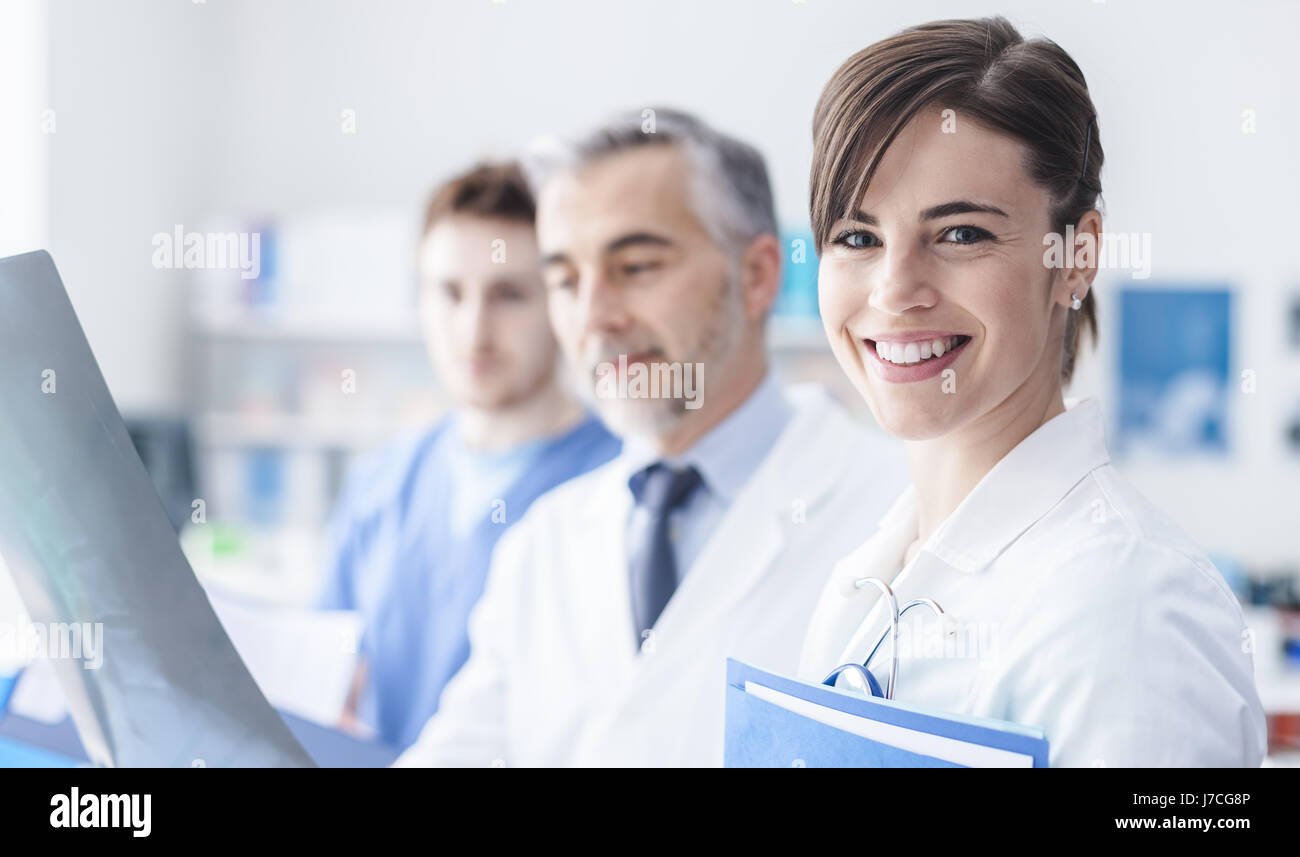 Professional medical team at the hospital examining a patient's x-ray ...