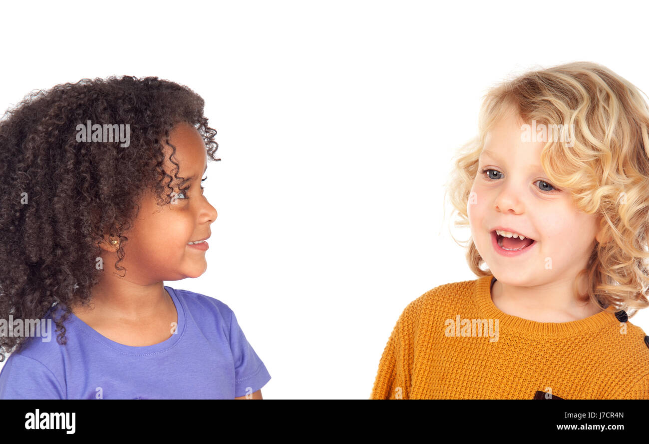 Two adorable children looking at each other isolated on a white ...