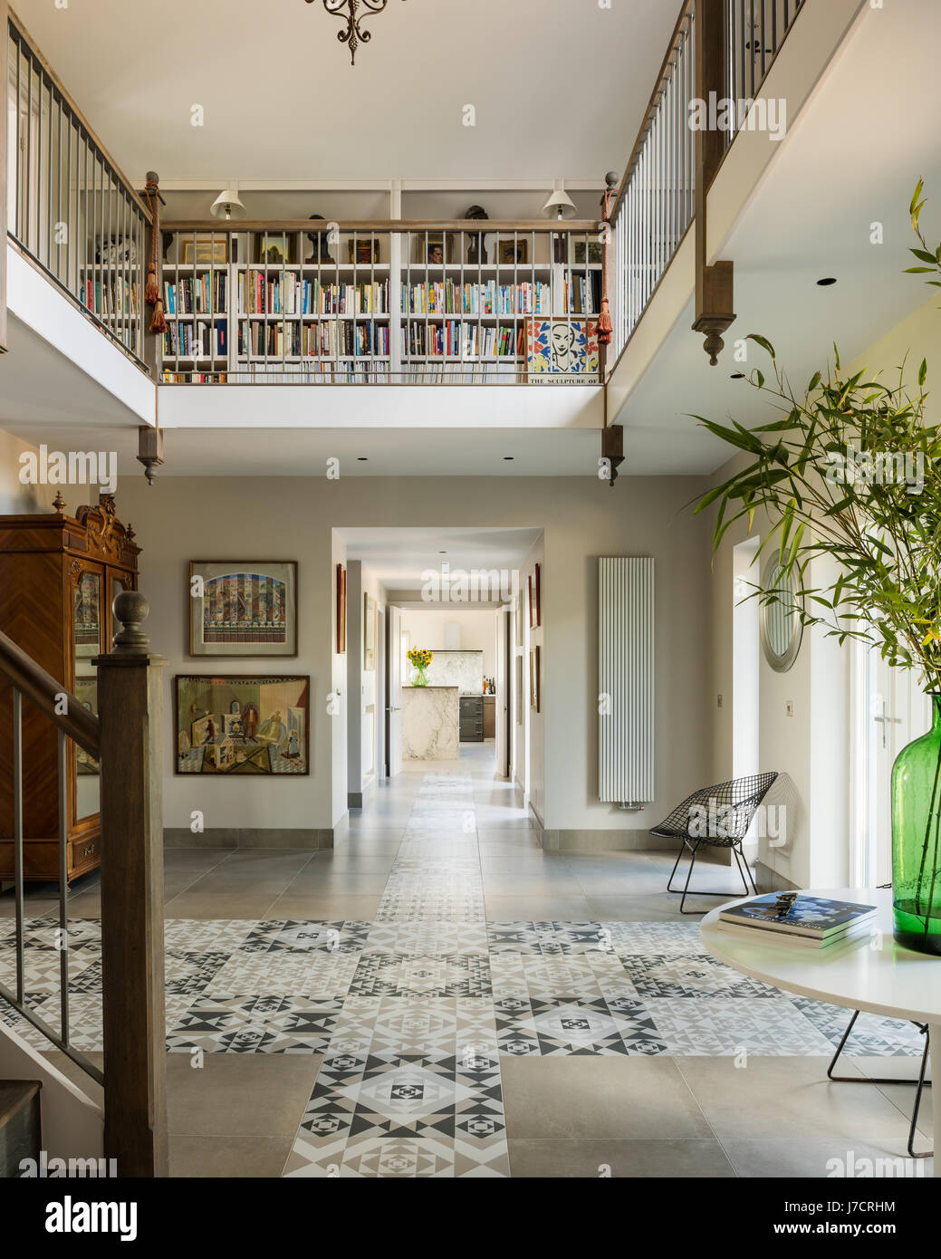 Reconfigured internal mezzanine with bold tiled floor alternating light ...