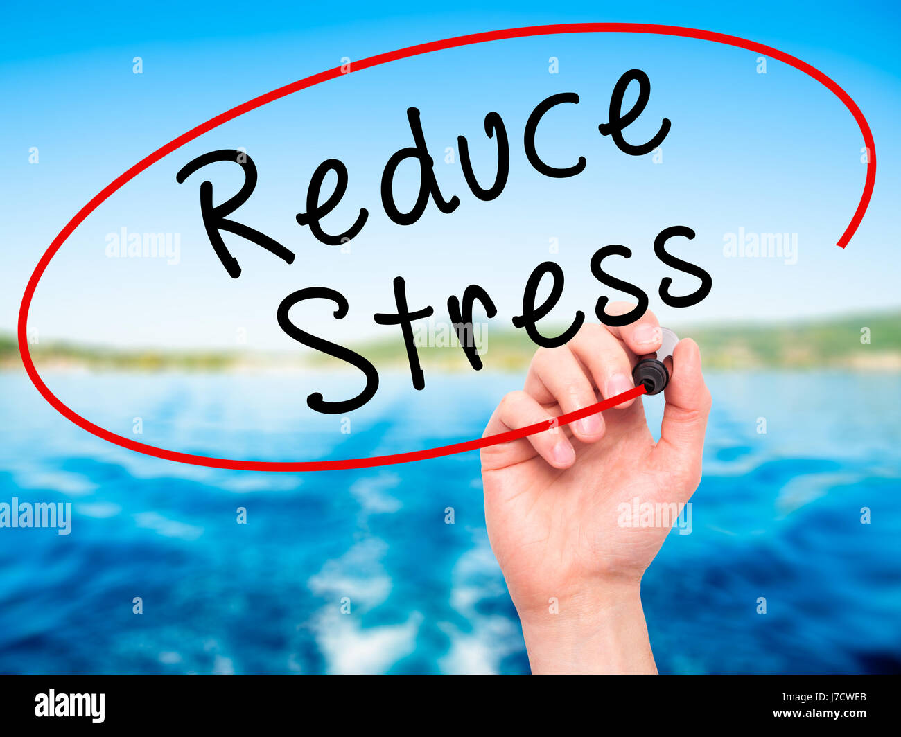Man Hand writing Reduce Stress with black marker on visual screen ...