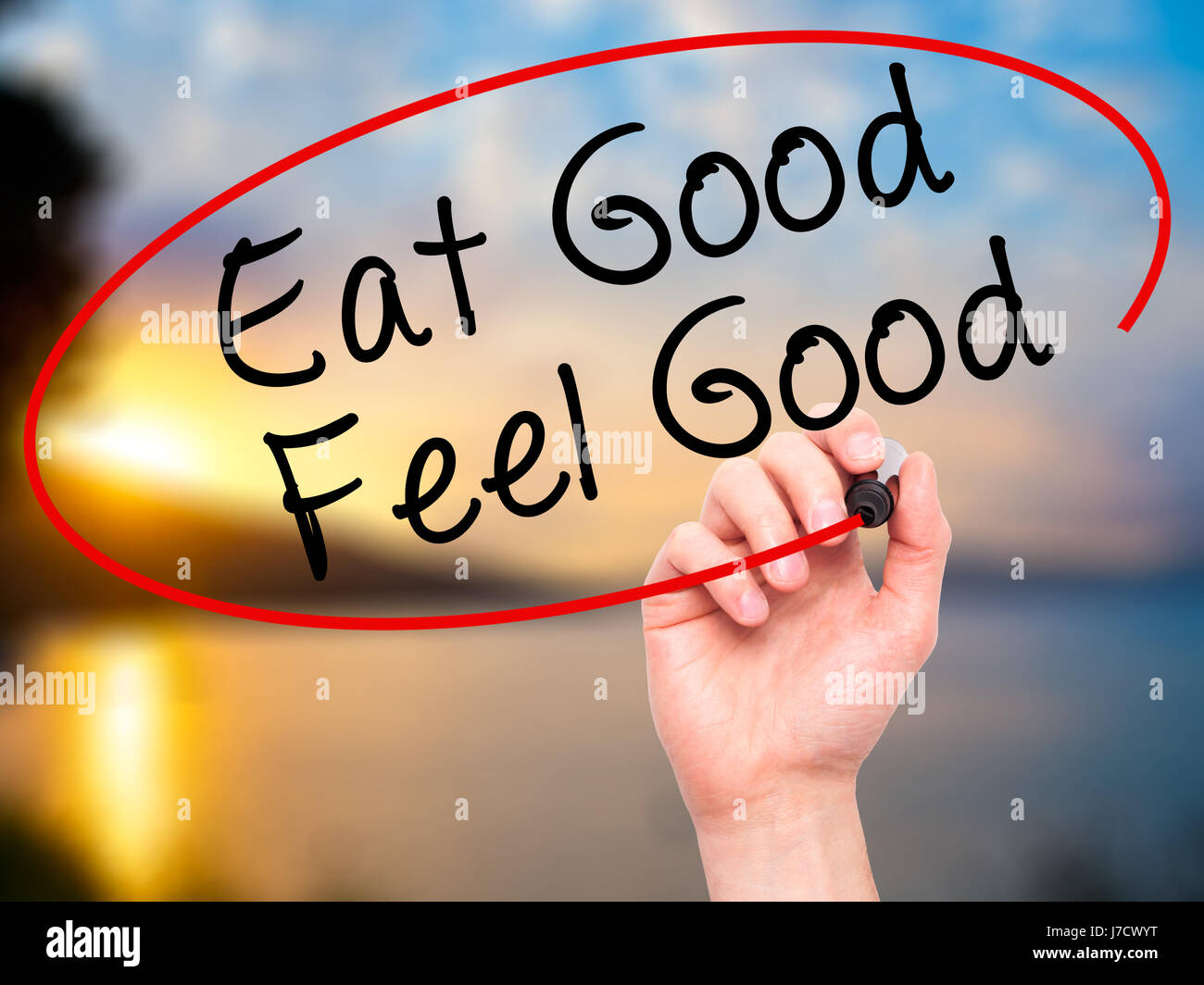 Man Hand writing Eat Good Feel Good with black marker on visual screen ...