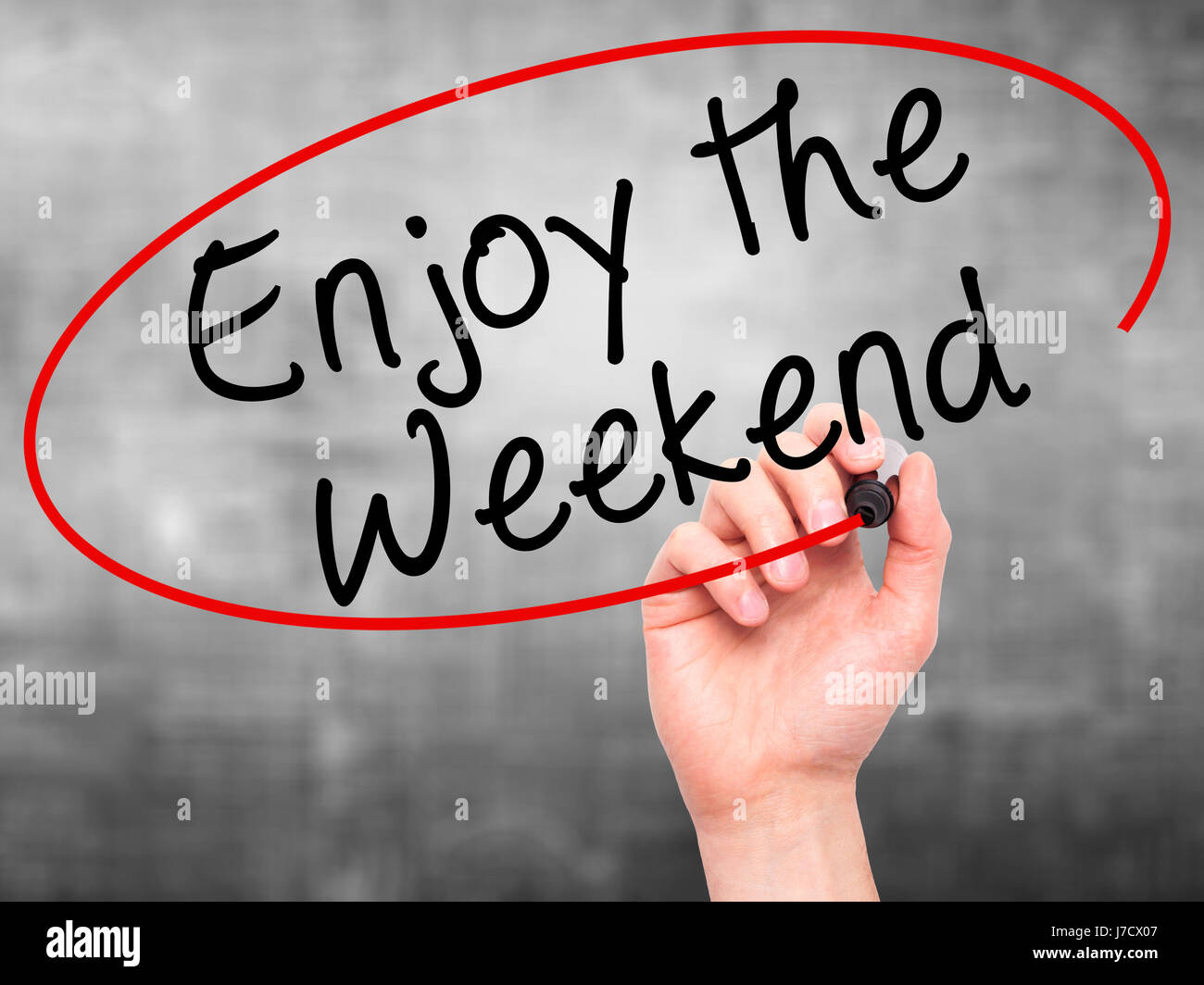 Man Hand writing Enjoy the Weekend with black marker on visual screen ...