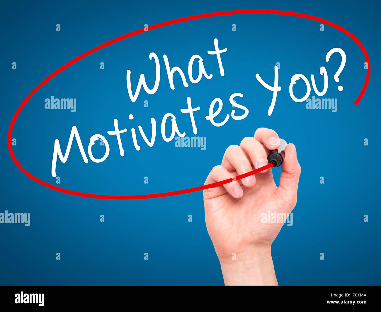 Man Hand writing What Motivates You? with black marker on visual screen ...