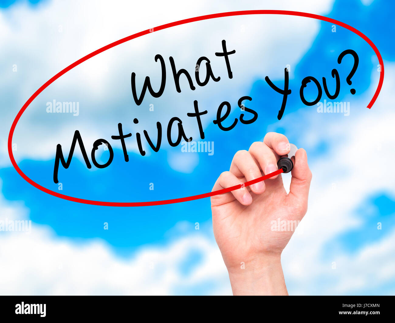 Man Hand writing What Motivates You? with black marker on visual screen ...