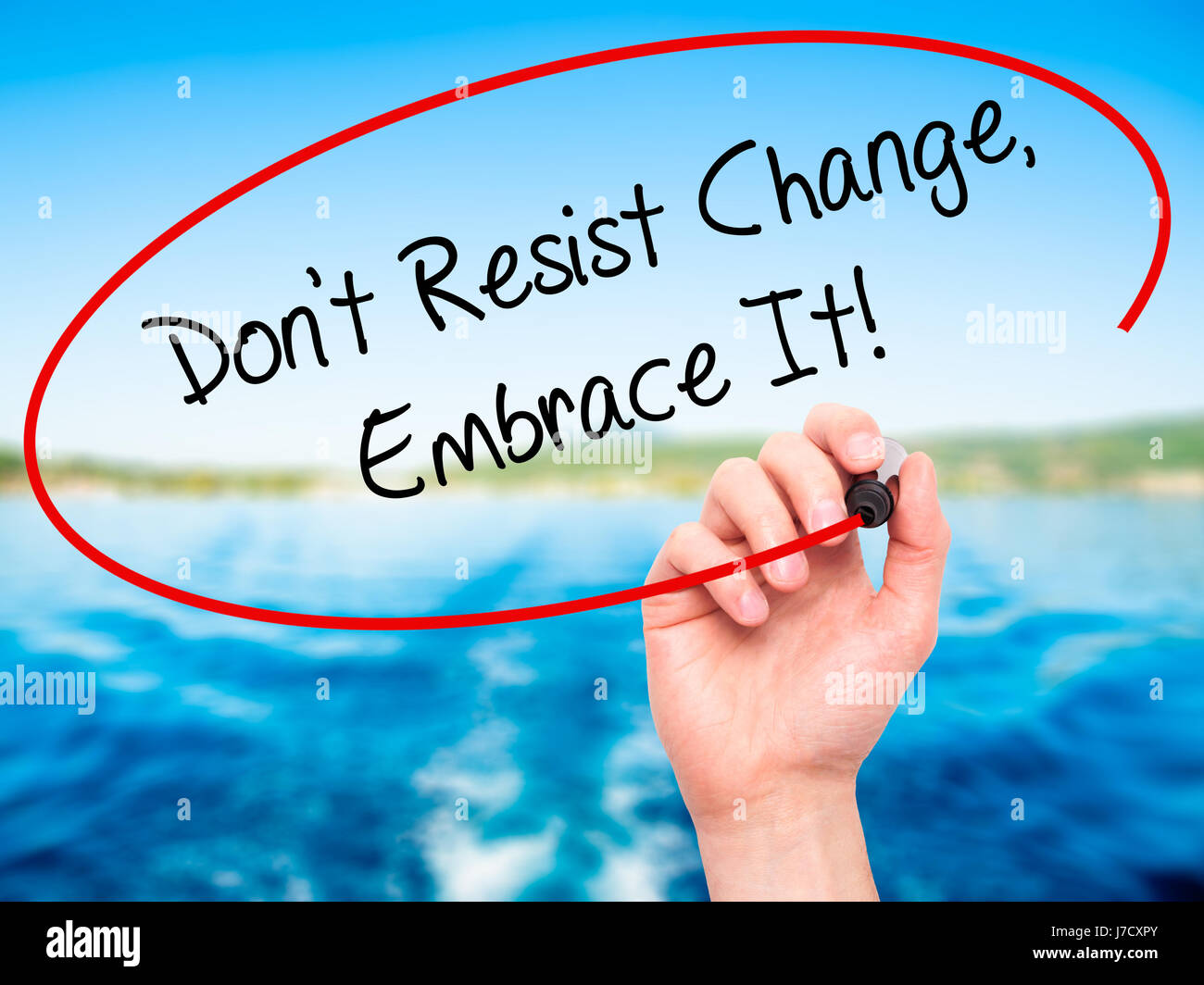 Man Hand writing Don't Resist Change, Embrace It! with black marker on ...