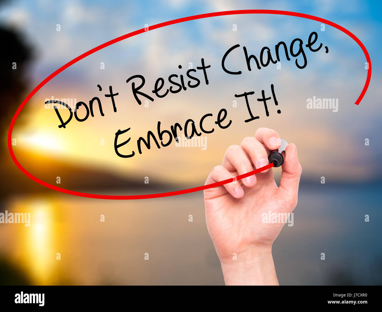 Man Hand writing Don't Resist Change, Embrace It! with black marker on ...