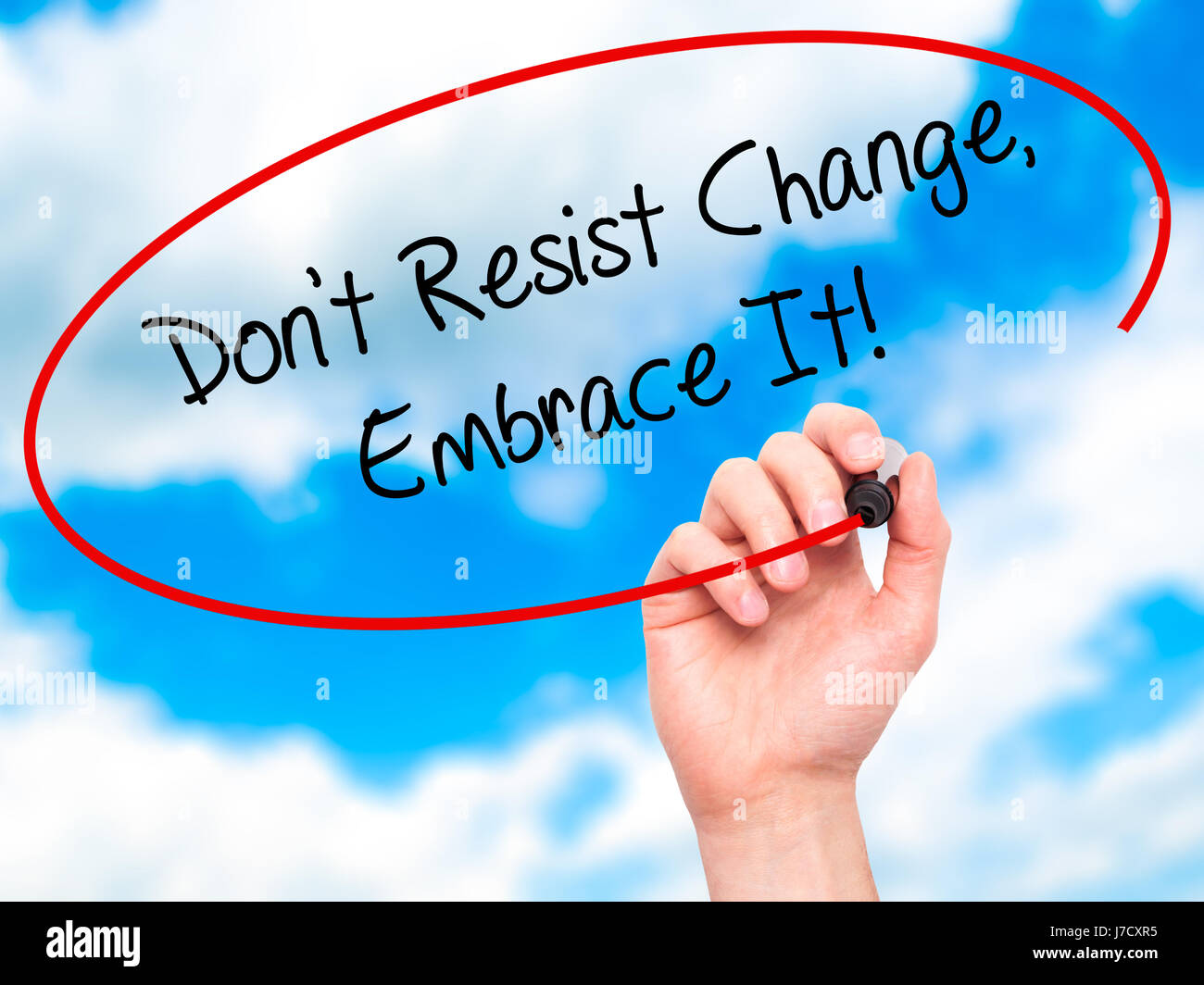 Man Hand writing Don't Resist Change, Embrace It! with black marker on ...