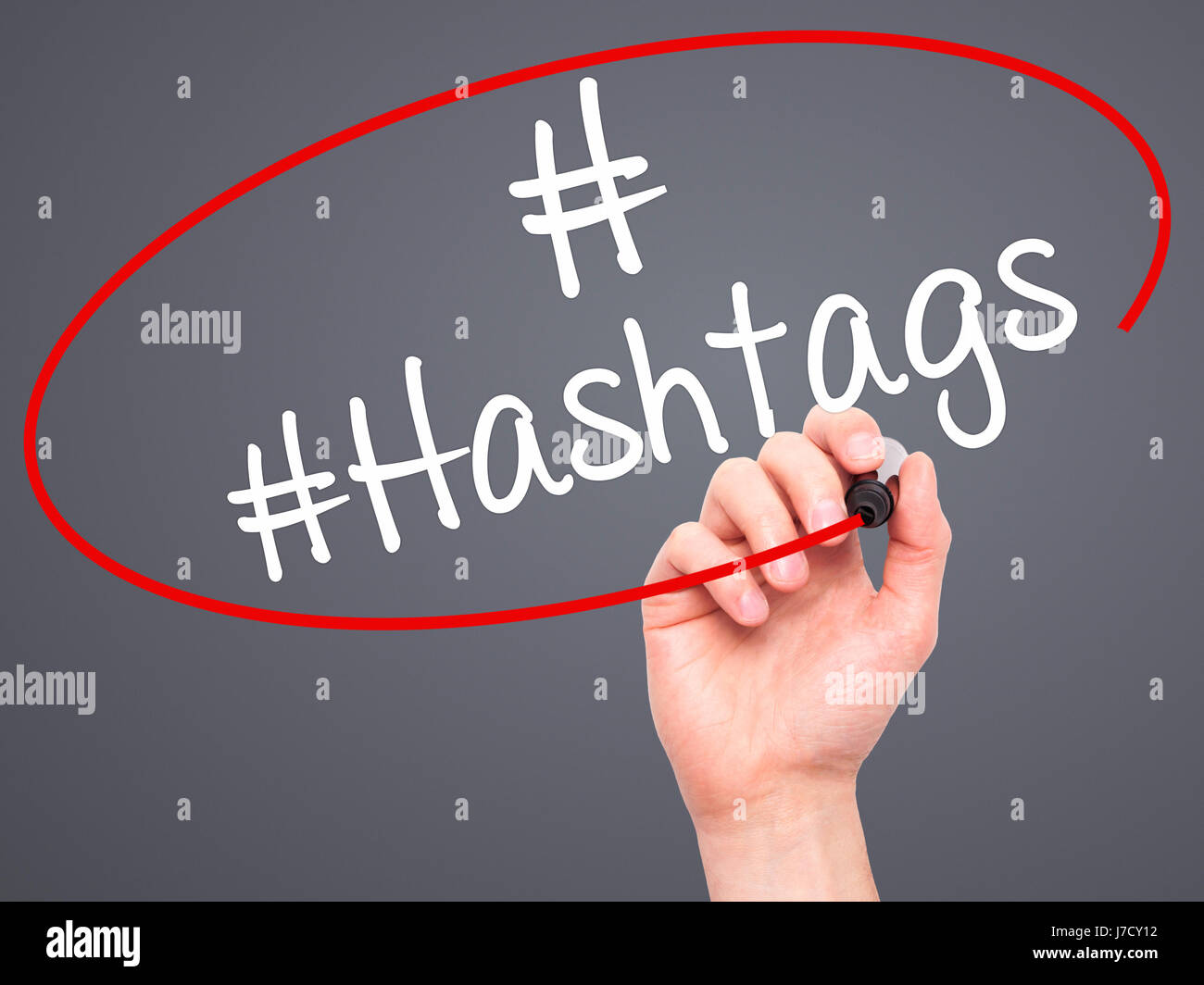 Man Hand writing #Hashtags with black marker on visual screen. Isolated ...