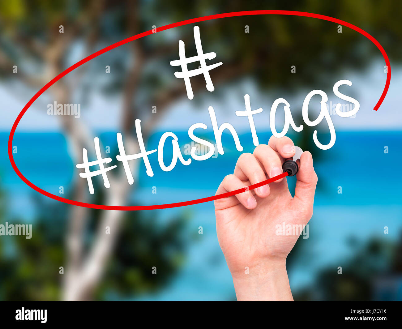 Man Hand writing #Hashtags with black marker on visual screen. Isolated ...