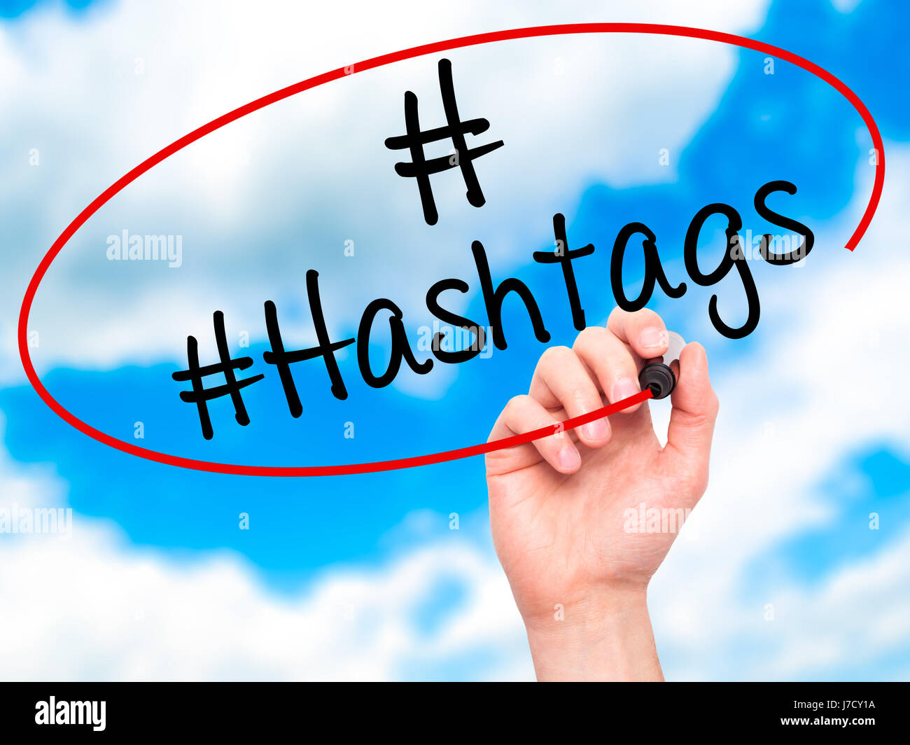 Man Hand writing #Hashtags with black marker on visual screen. Isolated ...