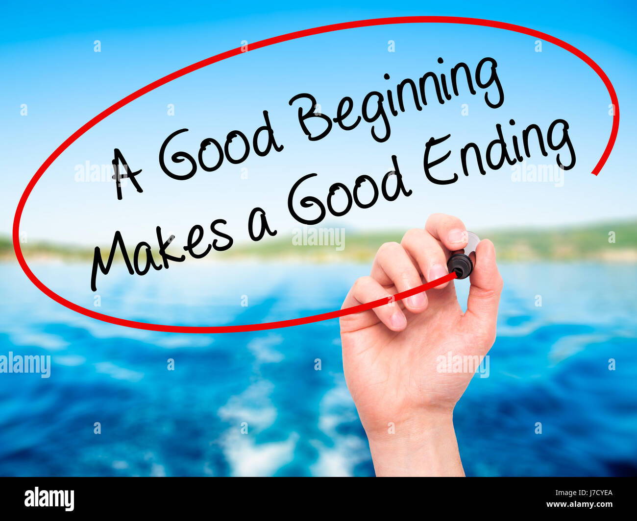 Man Hand writing A Good Beginning Makes a Good Ending with black marker ...