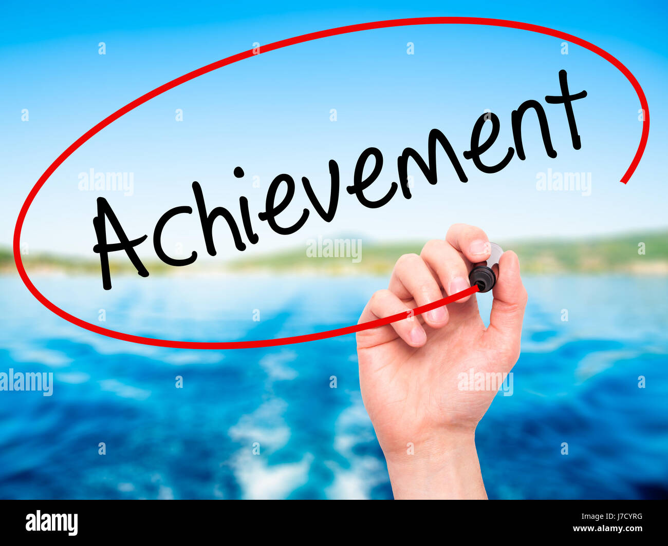 Man Hand writing Achievement with black marker on visual screen ...