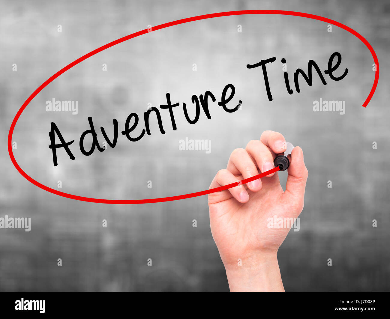 Man Hand writing Adventure Time with black marker on visual screen ...