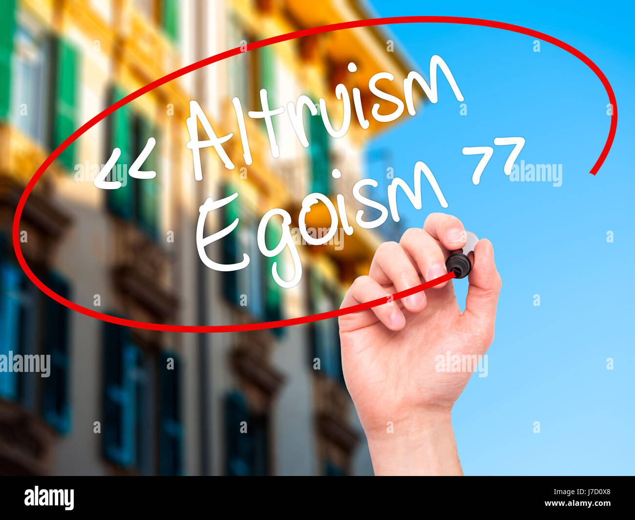 Man Hand writing Altruism - Egoism with black marker on visual screen ...