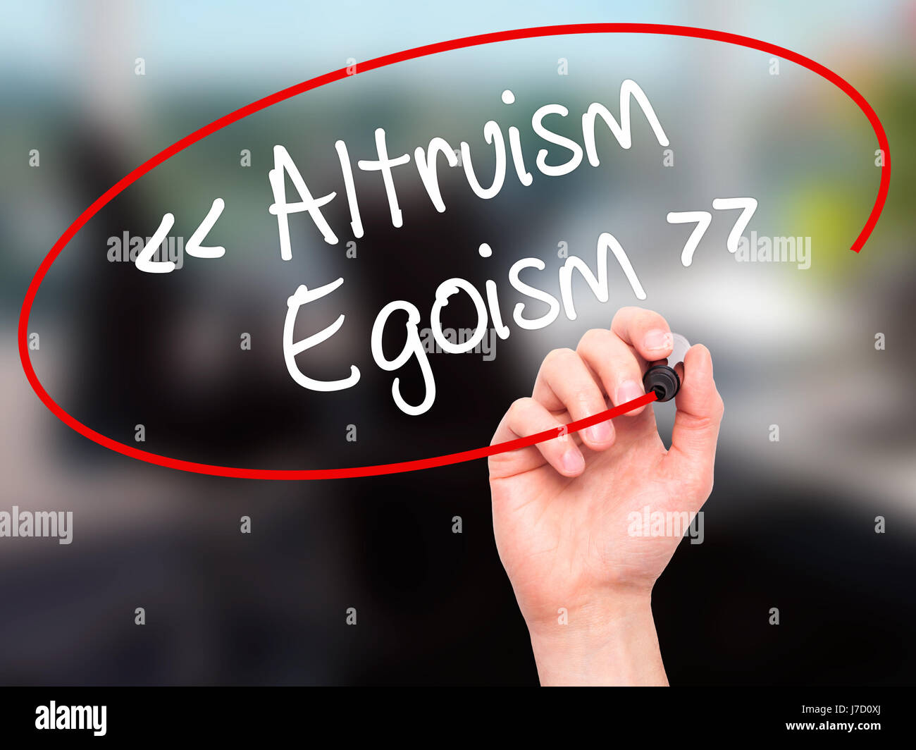 Man Hand writing Altruism - Egoism with black marker on visual screen ...