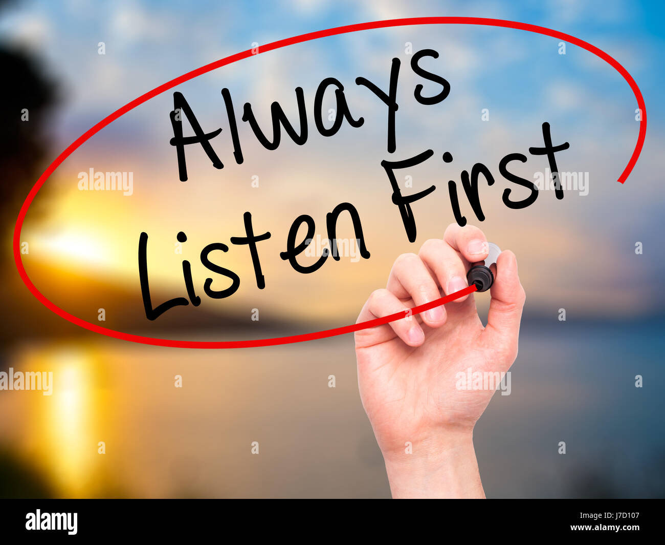 Man Hand writing Always Listen First with black marker on visual screen ...