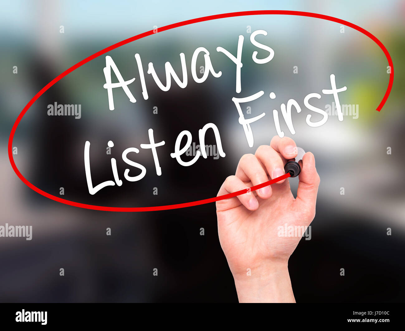 Man Hand writing Always Listen First with black marker on visual screen ...