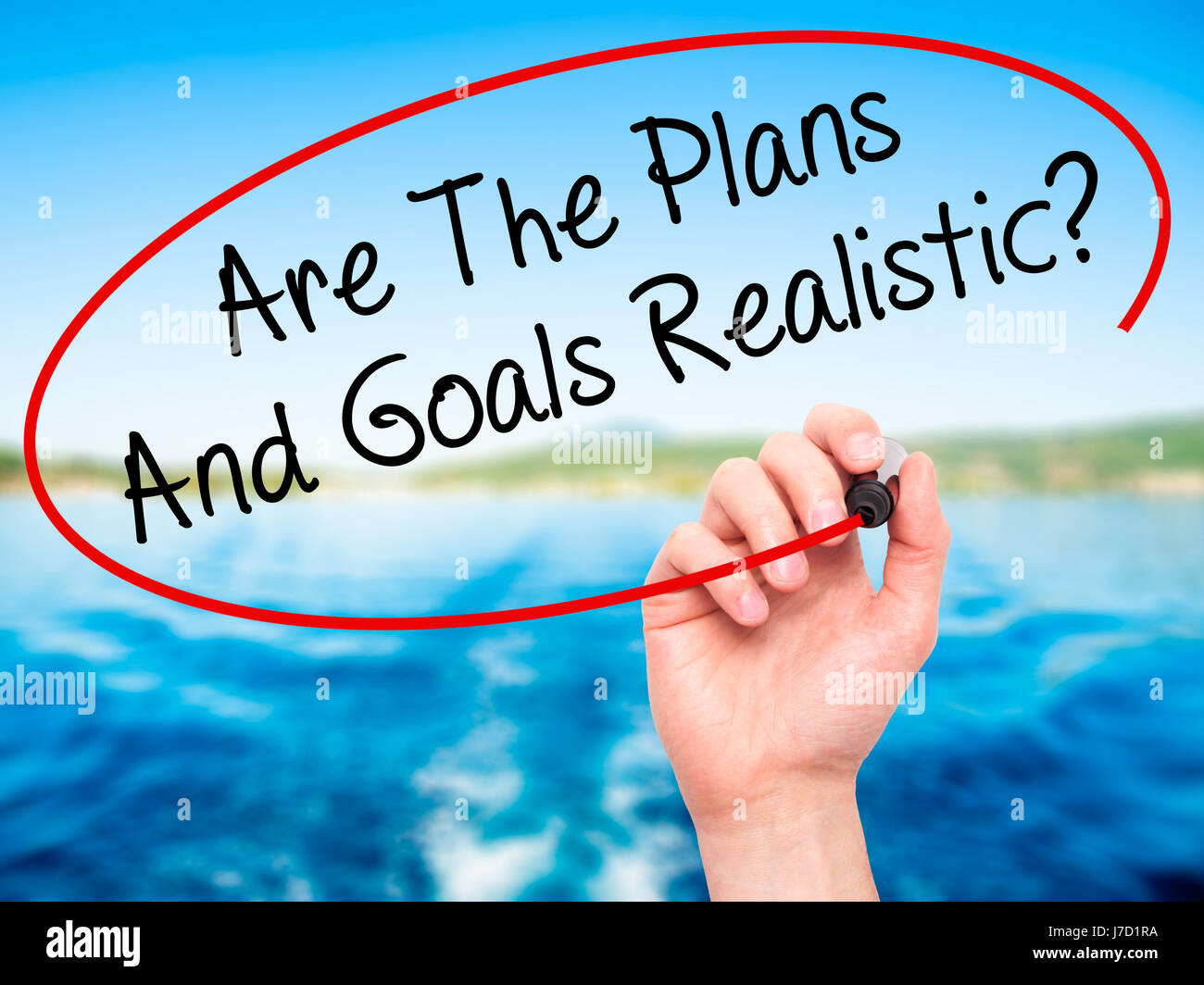 Man Hand writing Are The Plans And Goals Realistic? with black marker ...