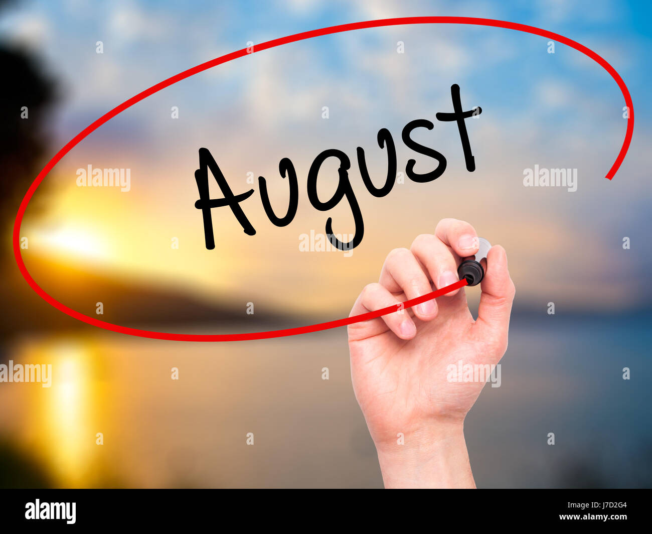 Man Hand writing August with black marker on visual screen. Isolated on ...