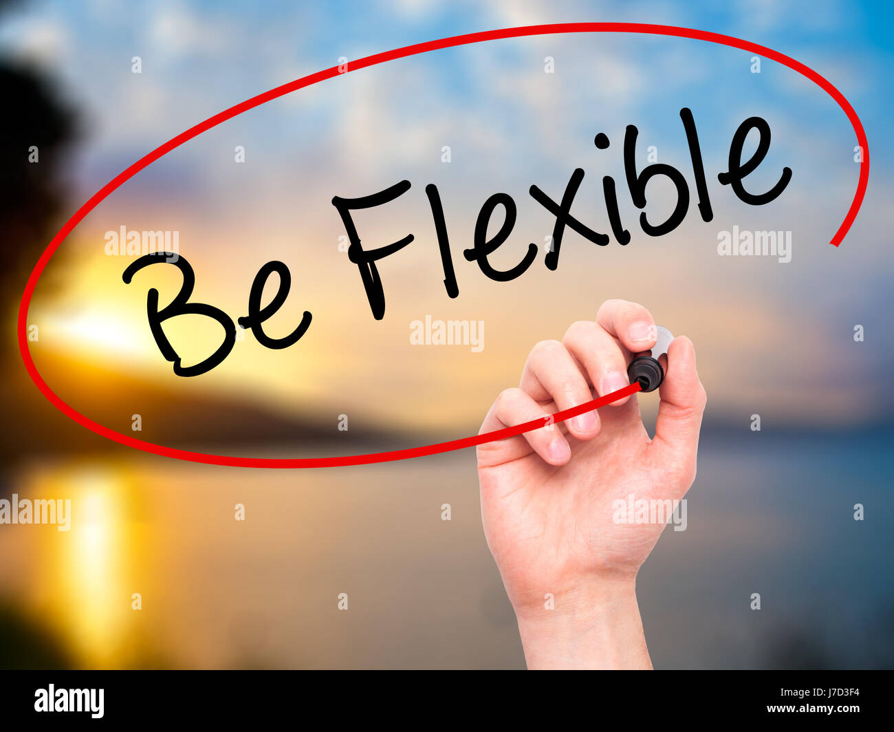 Man Hand writing Be Flexible with black marker on visual screen ...