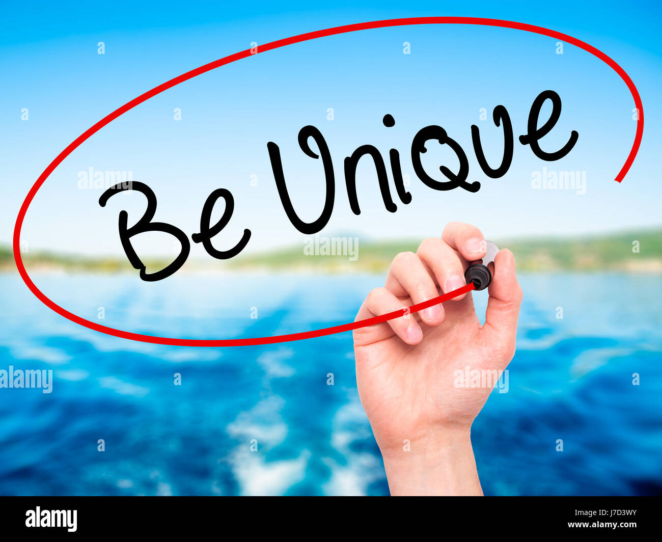 Man Hand writing Be Unique with black marker on visual screen. Isolated ...