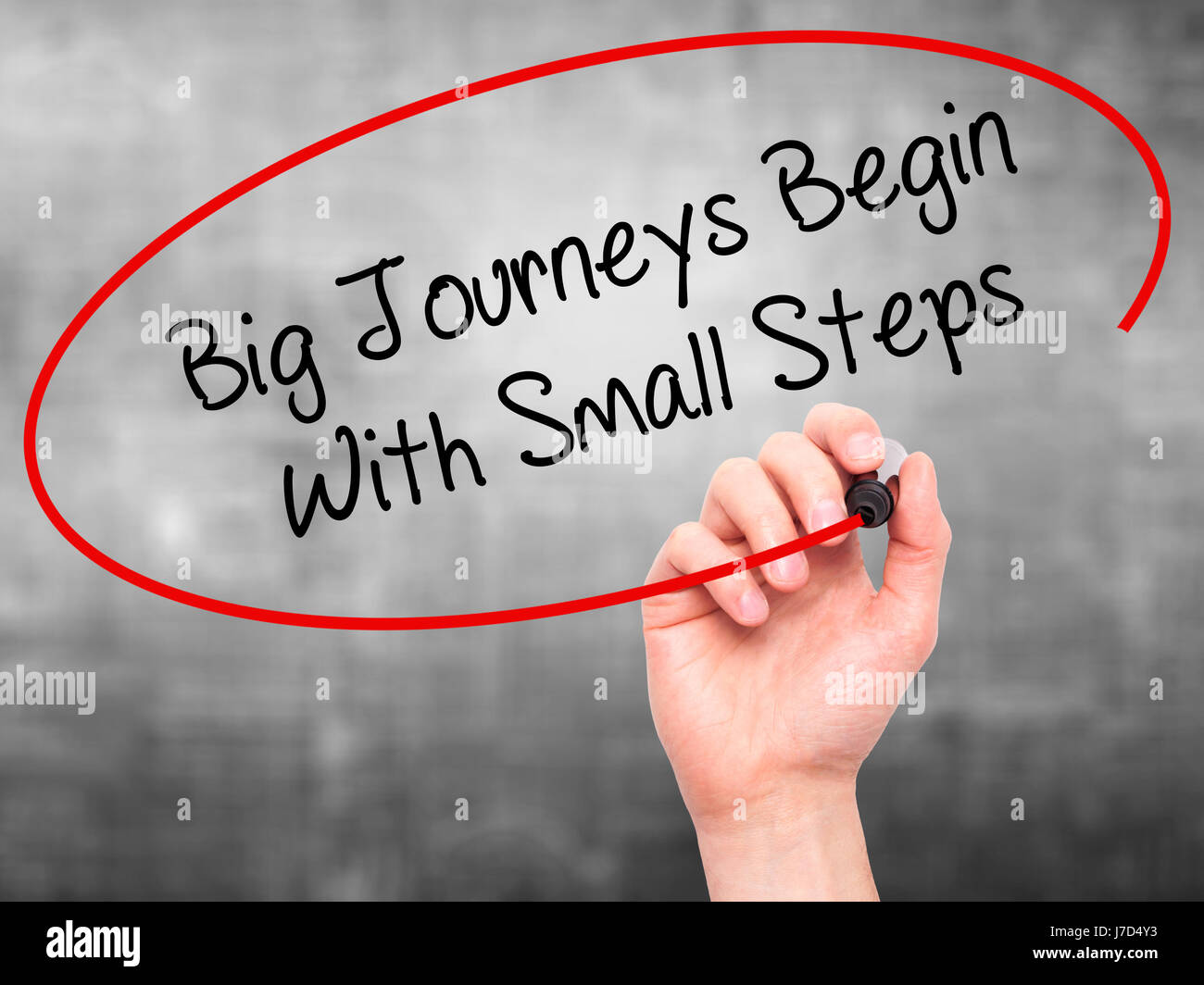 Man Hand writing Big Journeys Begin With Small Steps with black marker ...