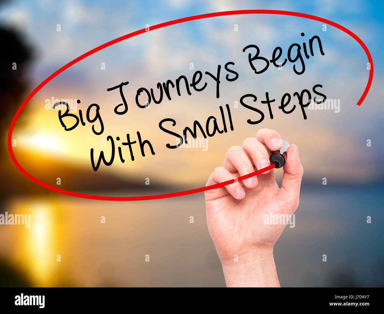 Man Hand writing Big Journeys Begin With Small Steps with black marker ...