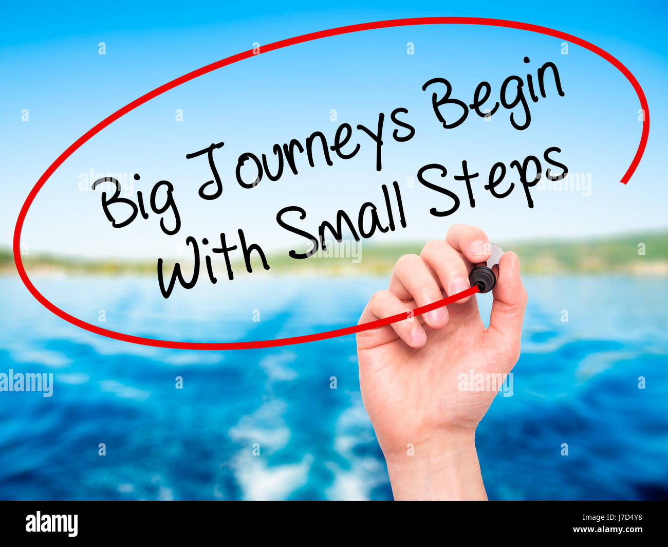Man Hand writing Big Journeys Begin With Small Steps with black marker ...