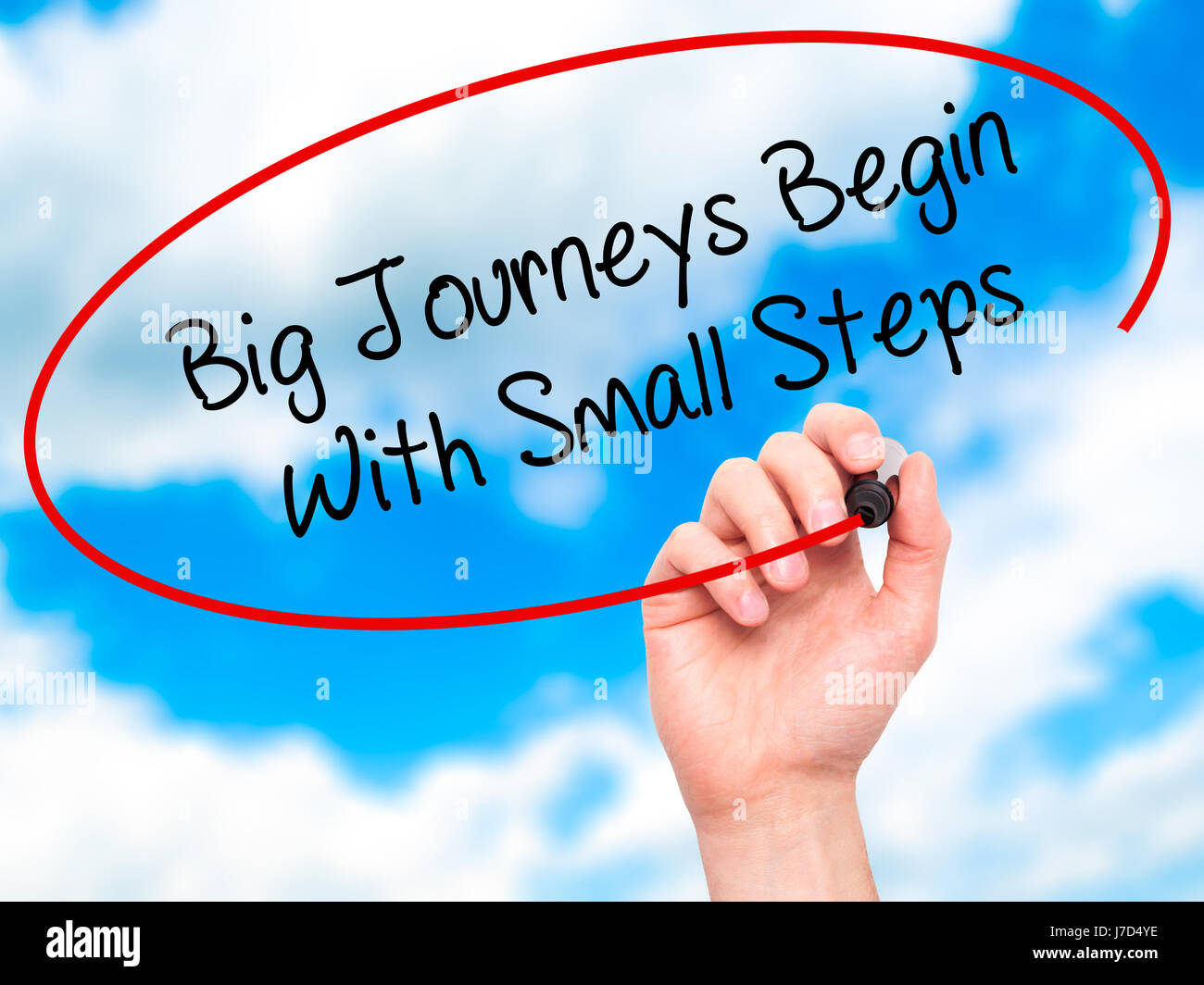 Man Hand writing Big Journeys Begin With Small Steps with black marker ...