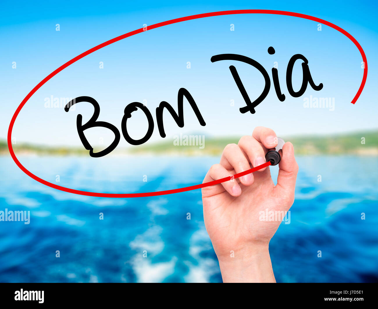Man Hand writing "Bom Dia" (In portuguese - Good Morning) with black ...