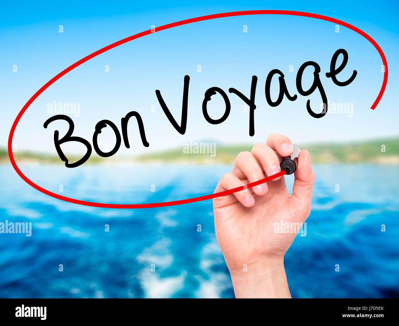 Man Hand writing Bon Voyage (Have a Good Trip In French) with black ...