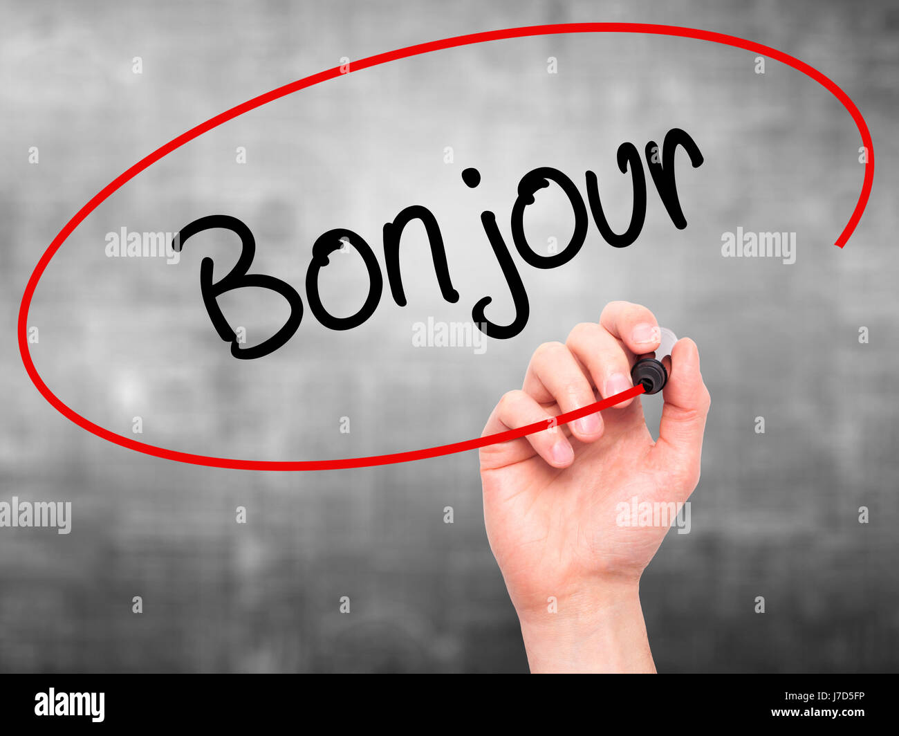 Man Hand writing Bonjour (Good Morning in French) with black marker on ...