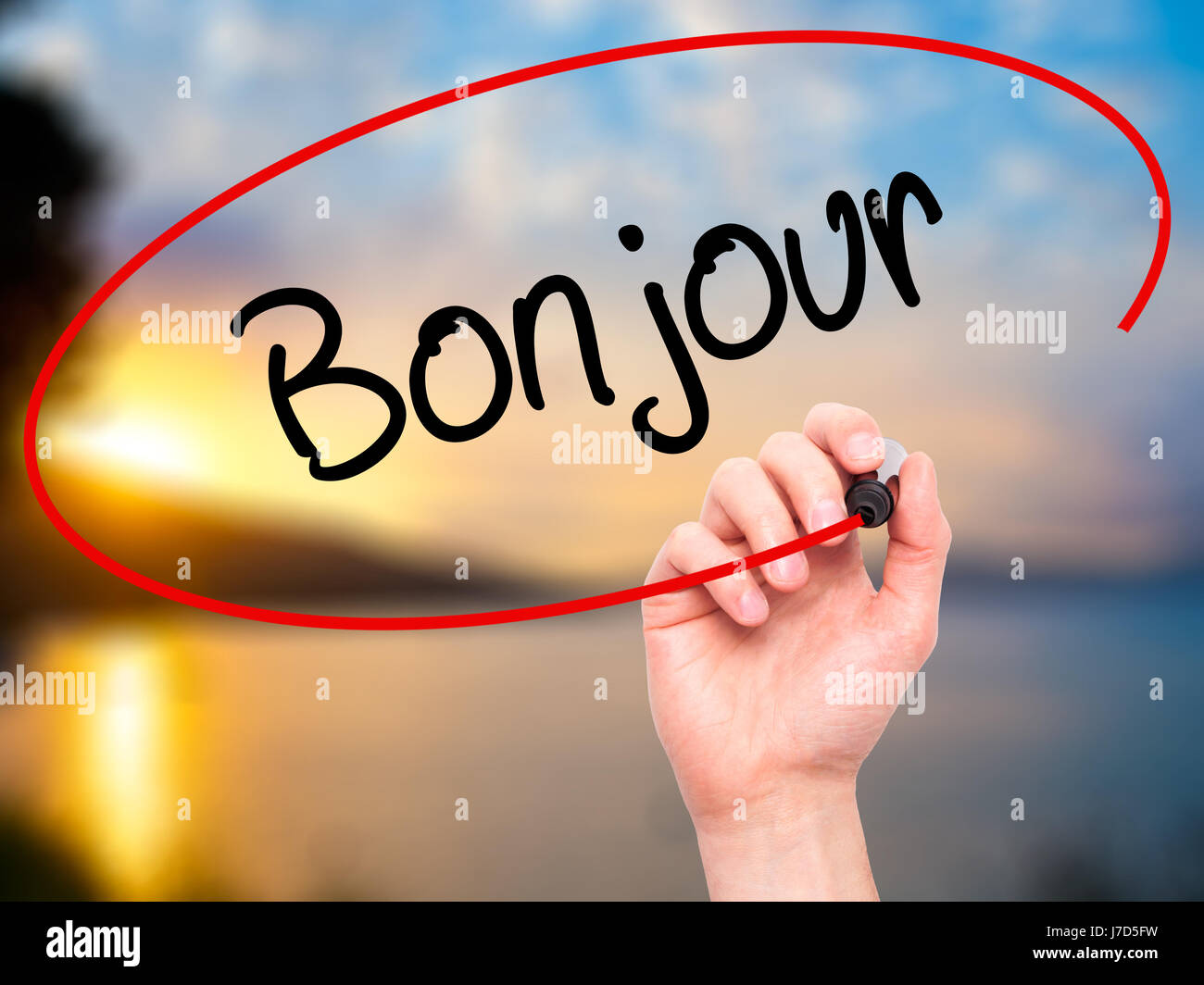 Man Hand writing Bonjour (Good Morning in French) with black marker on ...