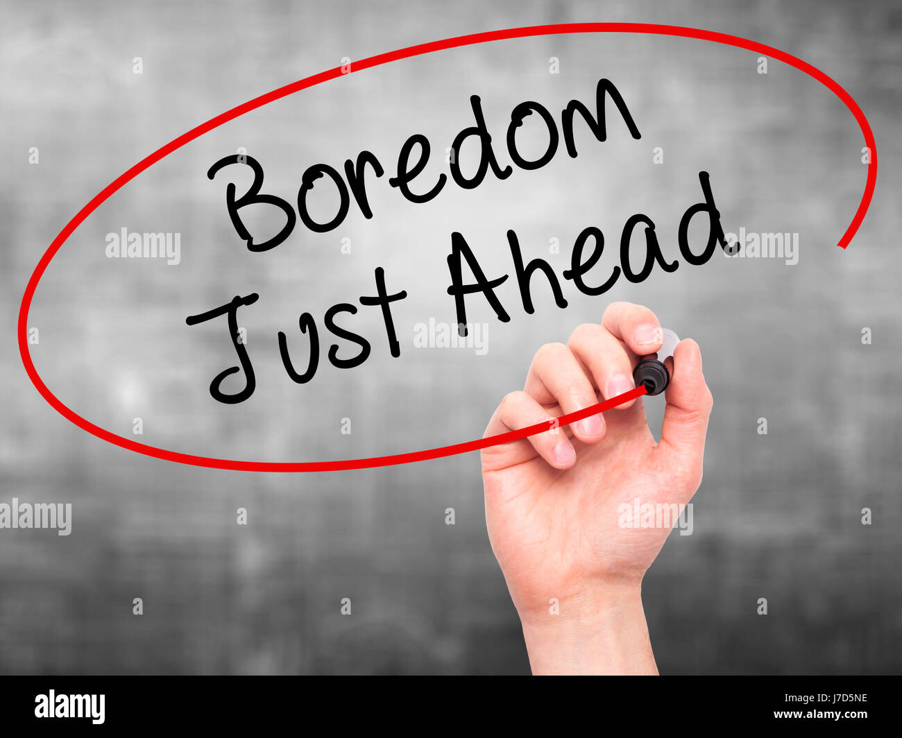 Man Hand writing Boredom Just Ahead with black marker on visual screen ...