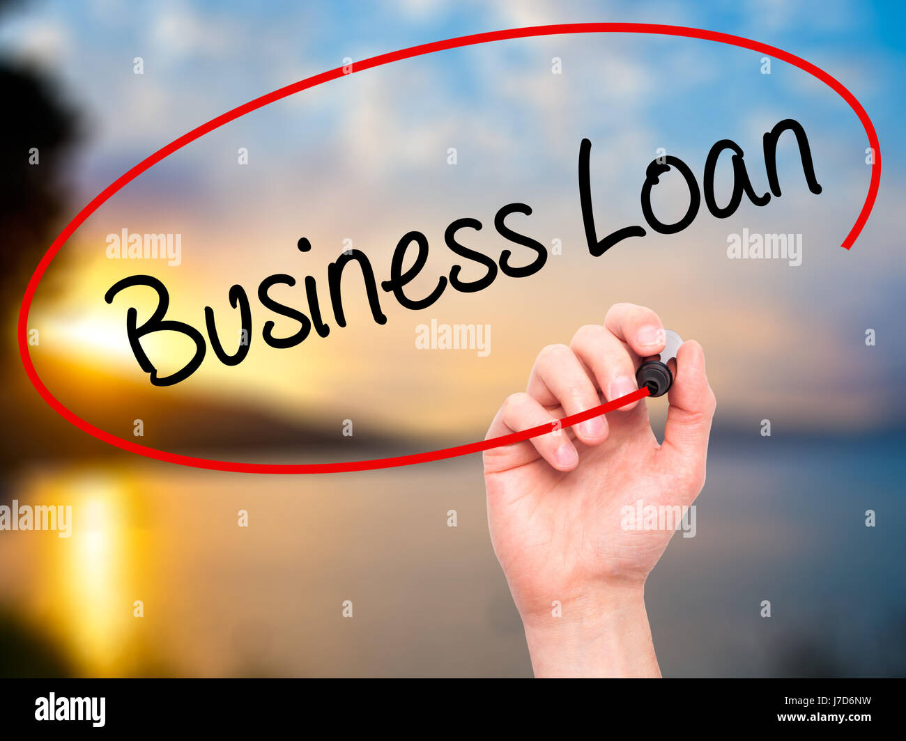 Man Hand writing Business Loan with black marker on visual screen ...