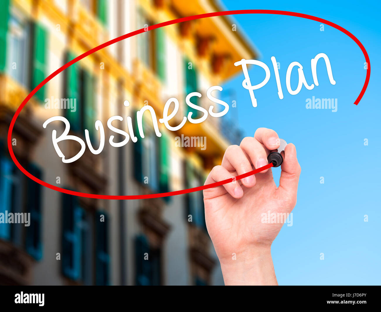 Man Hand writing Business Plan with black marker on visual screen ...