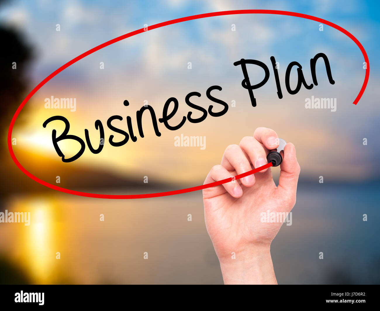 Man Hand writing Business Plan with black marker on visual screen ...