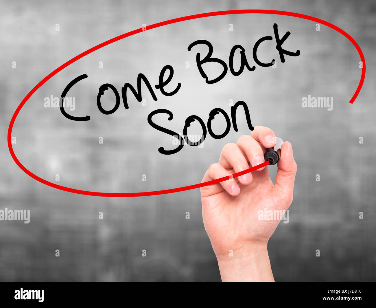 Man Hand writing Come Back Soon with black marker on visual screen ...
