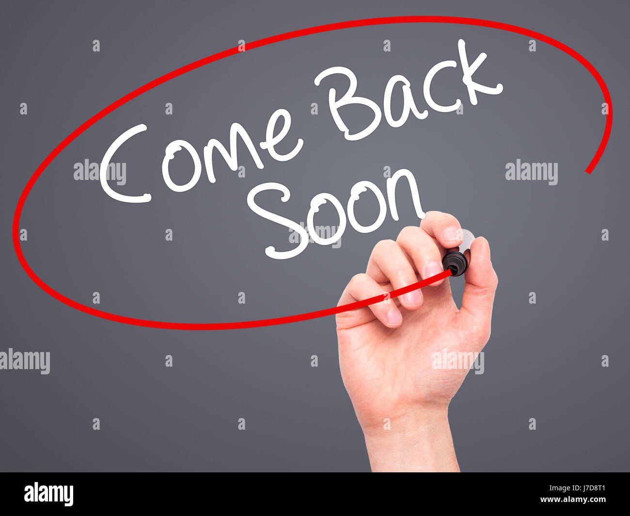 Man Hand writing Come Back Soon with black marker on visual screen ...