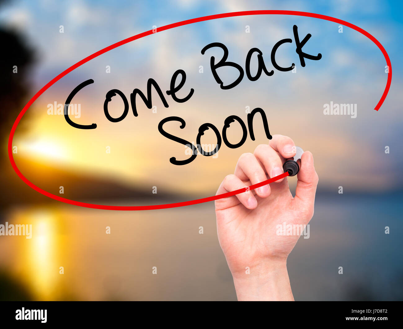 Man Hand writing Come Back Soon with black marker on visual screen ...