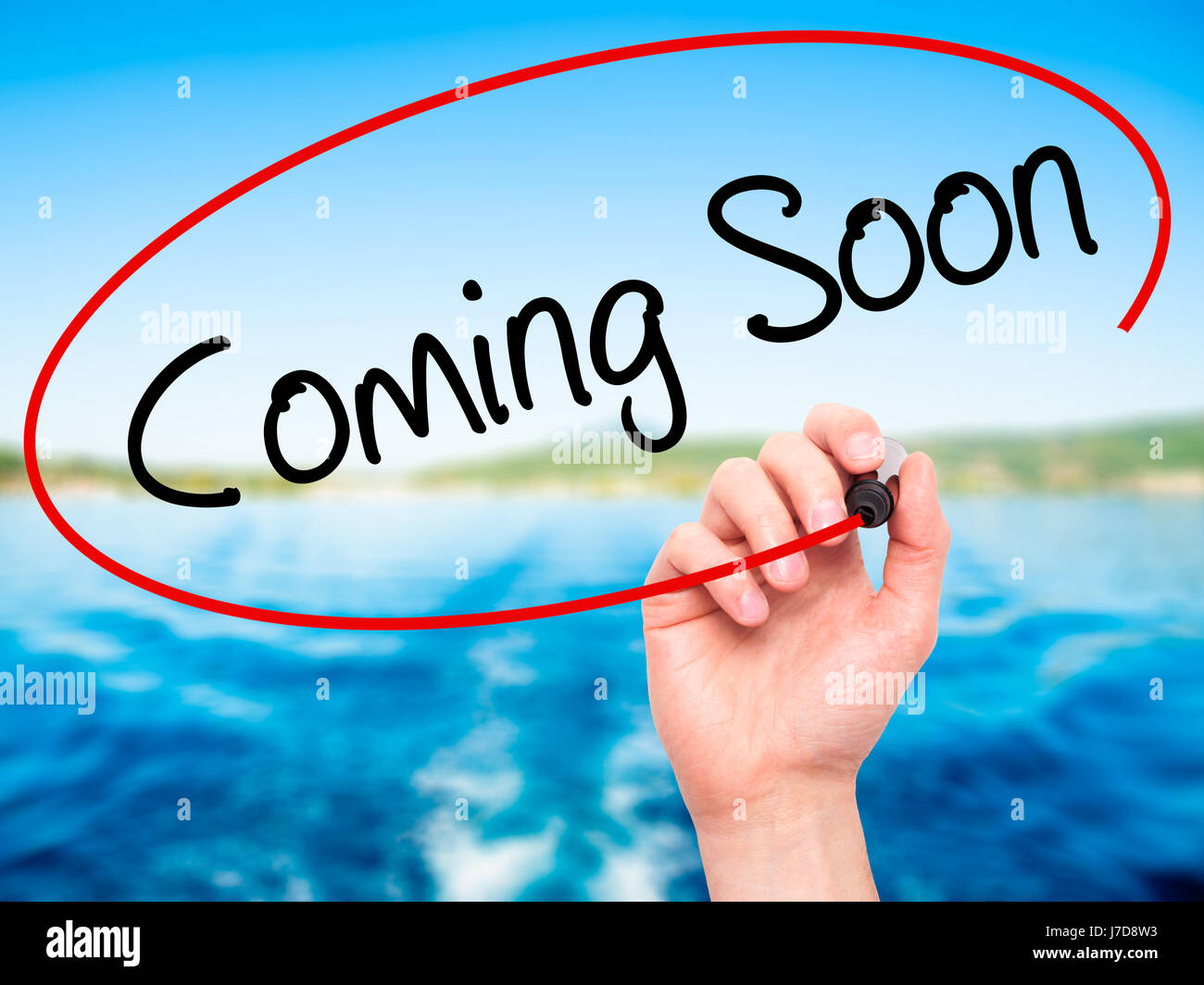 Man Hand writing Coming Soon with black marker on visual screen ...
