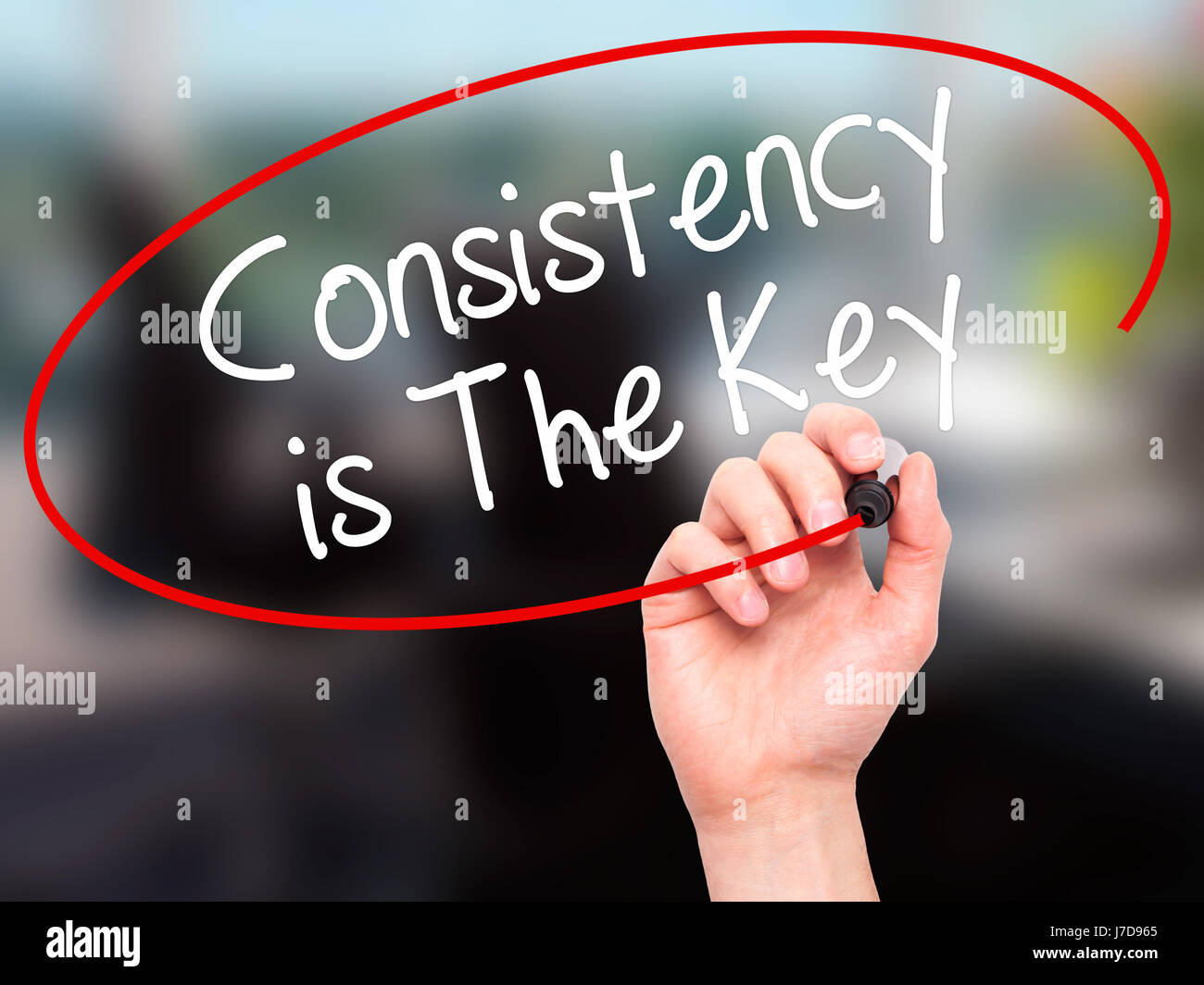 Man Hand writing Consistency is The Key with black marker on visual ...