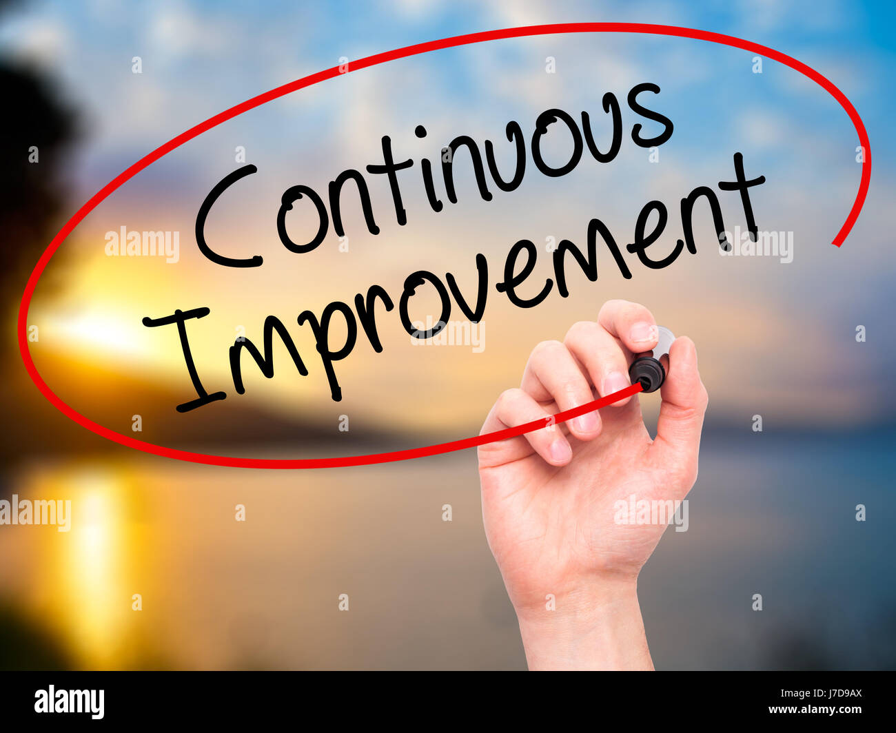 Man Hand writing Continuous Improvement with black marker on visual ...