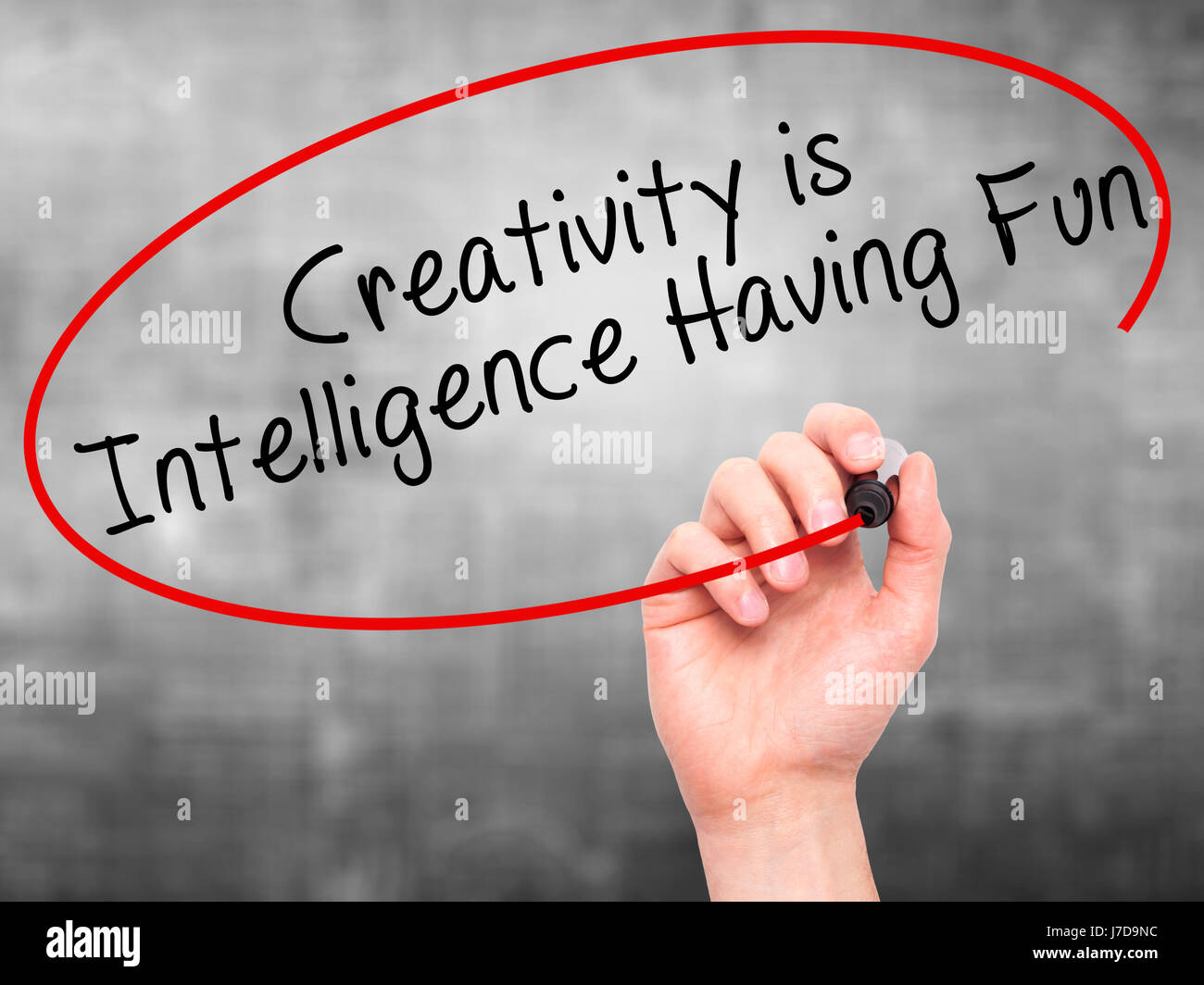 Man Hand writing Creativity is Intelligence Having Fun with black ...