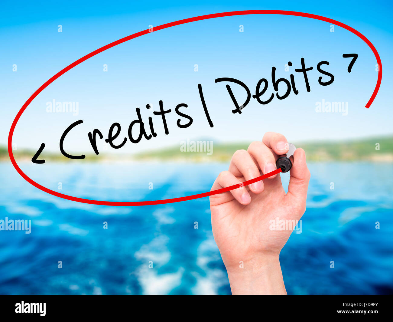 Man Hand writing Credits - Debitswith black marker on visual screen ...