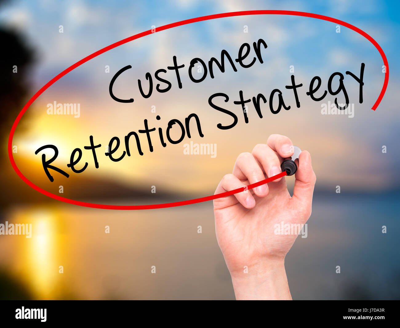 Man Hand writing Customer Retention Strategy with black marker on ...