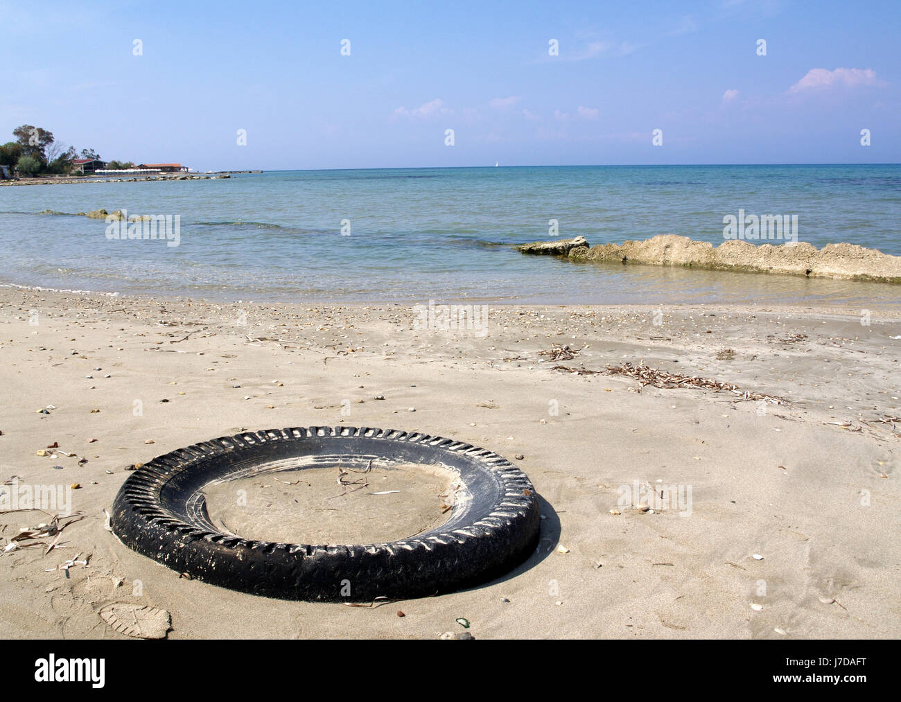 Old lorry tyre washed ashore at Roda Beach, Corfu, Greece Stock Photo ...